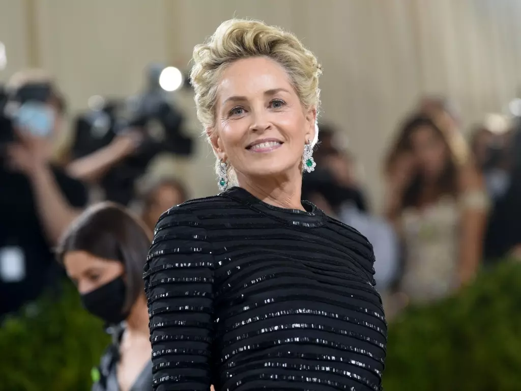 USharon Stone ubekwe kwiSuti yokuhlamba eSlinky emnyama kwesi sikhumbuzo siBomvu-Sishushu sokubeka phambili ukuZikhathalela