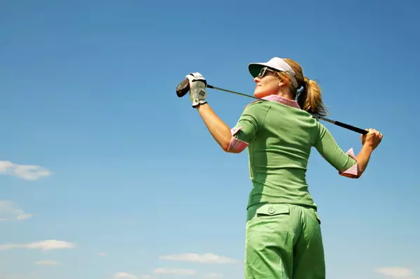 Woman golfing